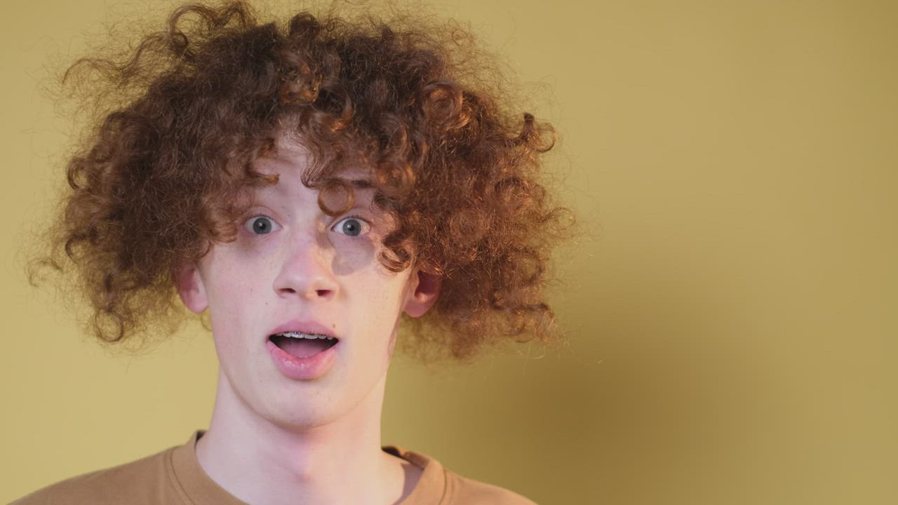 Young curly-red-haired man making a shocking expression - Free Stock Video