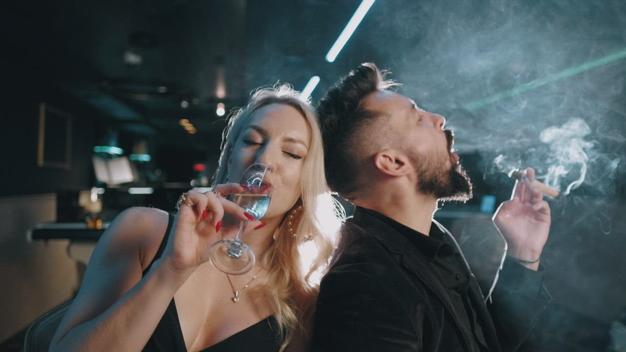 Woman and man on a party drinking and smoking - Free Stock Video