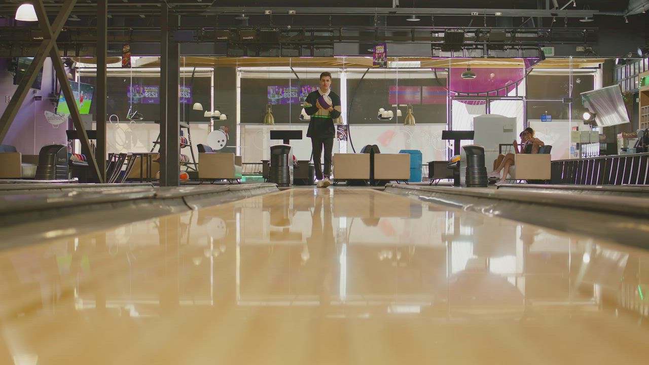 A young man makes a bowling shot - Free Stock Video