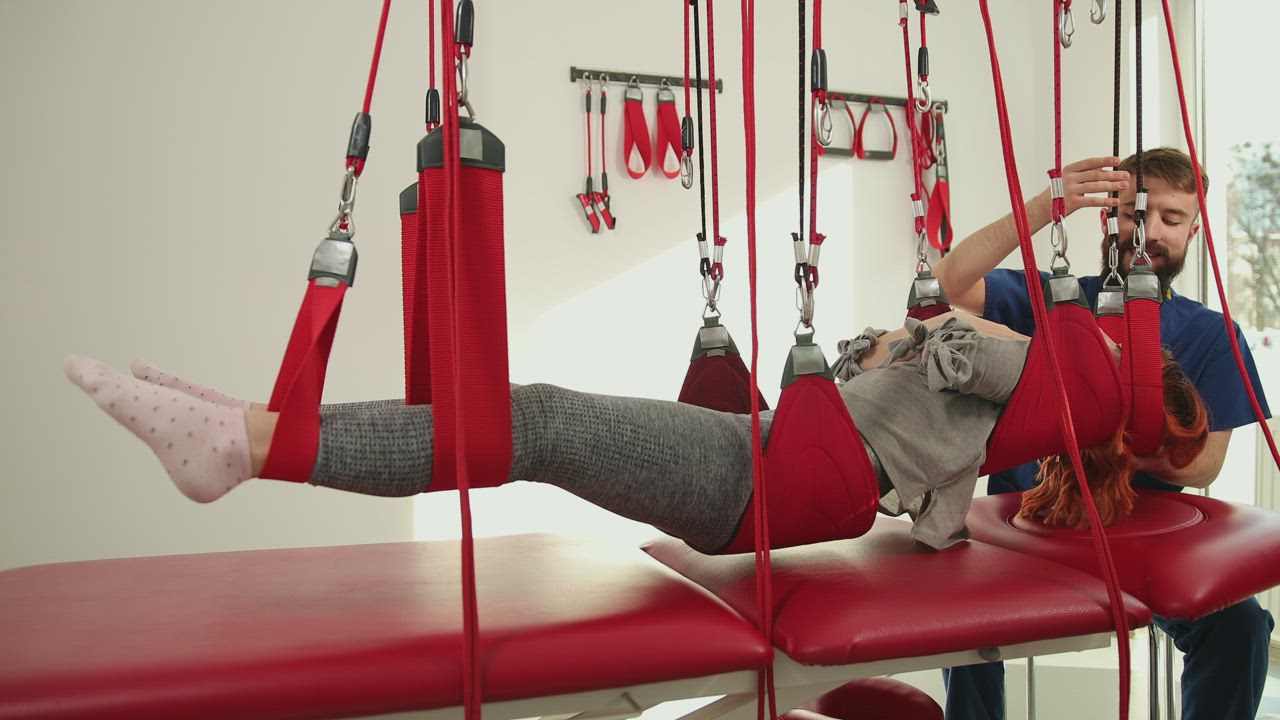 Woman having a back and neck adjustment by chiropractic professinal ...