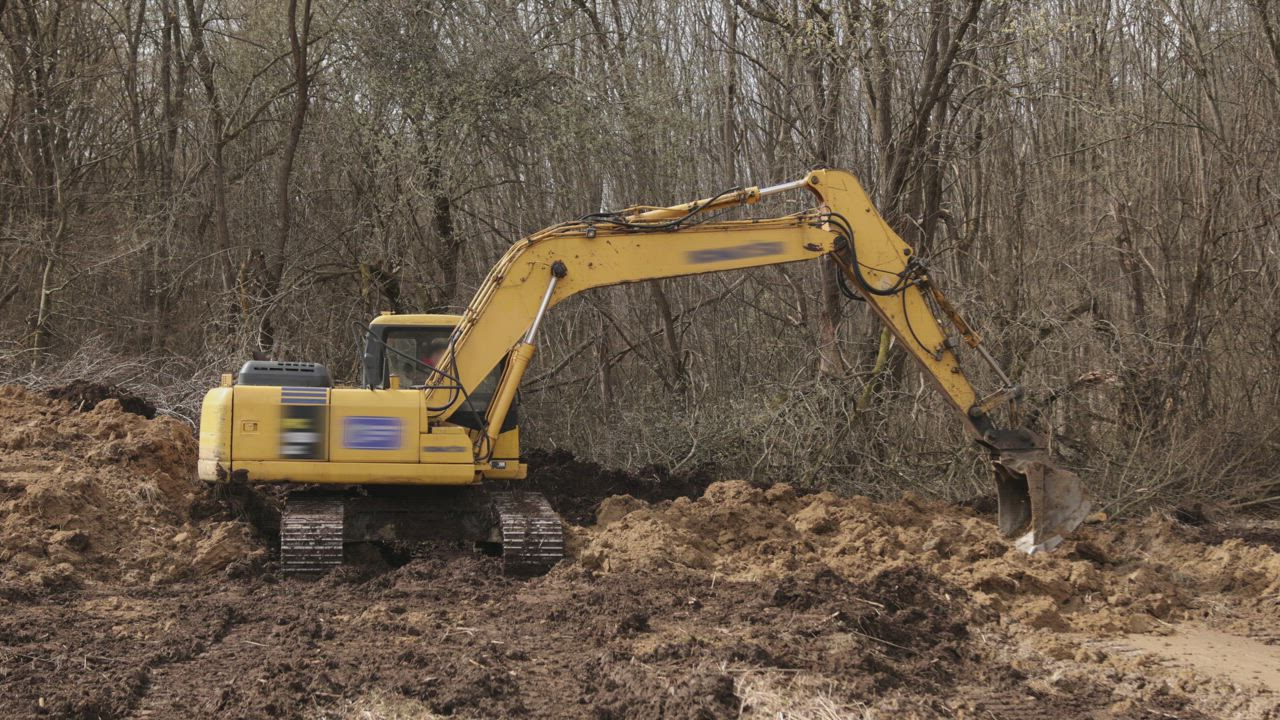 Loader in action digging soil - Free Stock Video