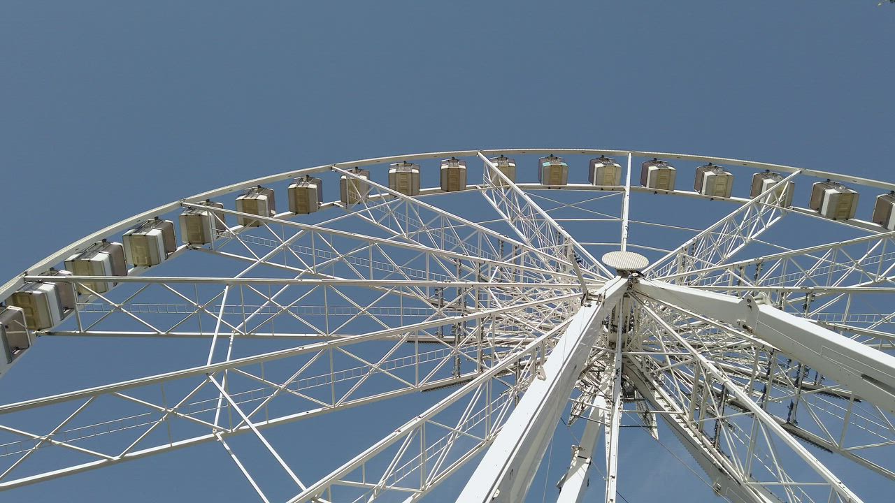 Large white ferris wheel at a fairground - Free Stock Video