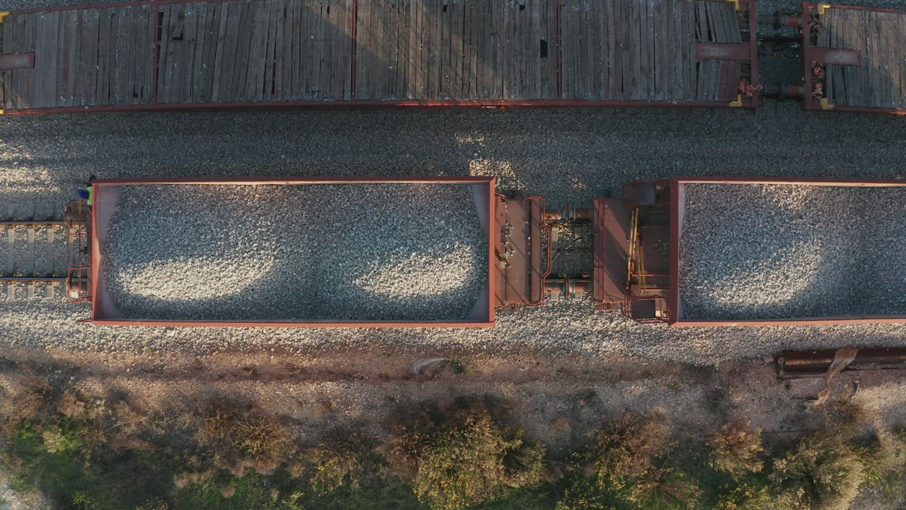 Aerial view of a freight train filled with gravel ready for transport ...