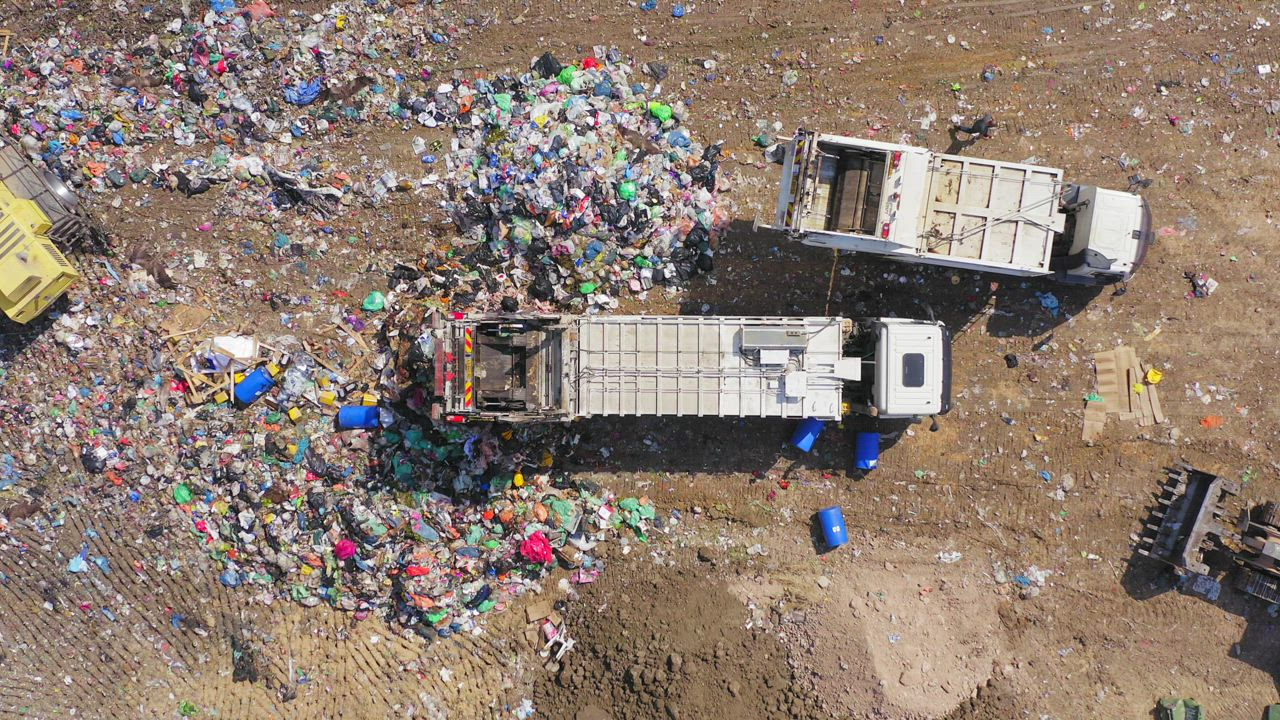 Garbage trucks dumping rubbish in landfill - Free Stock Video