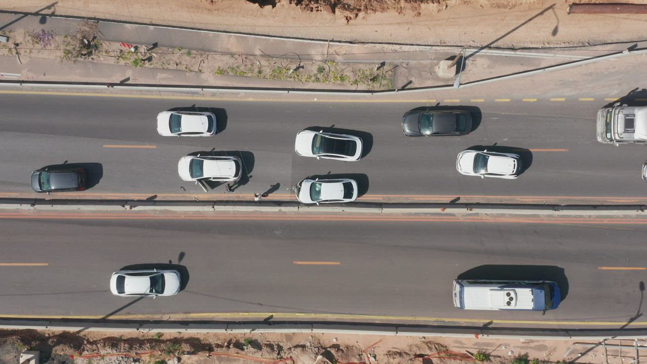 Aerial view of a car accident on a busy highway - Free Stock Video