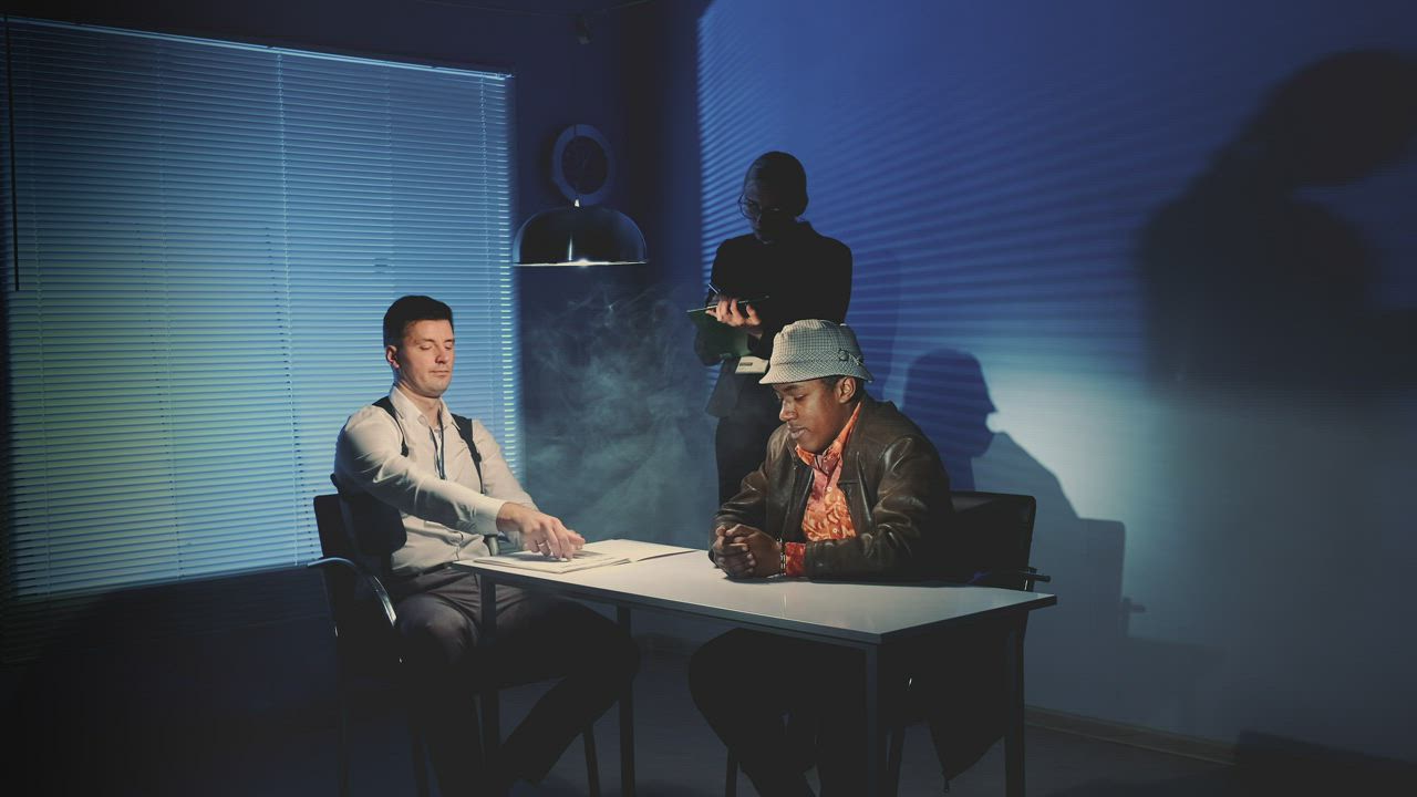 Detectives interrogating a suspect in a police station - Free Stock Video