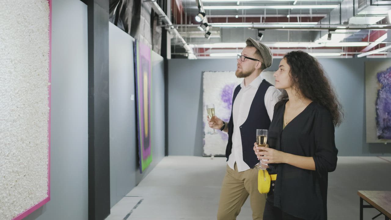 Couple commenting on a painting at the art exhibition - Free Stock Video