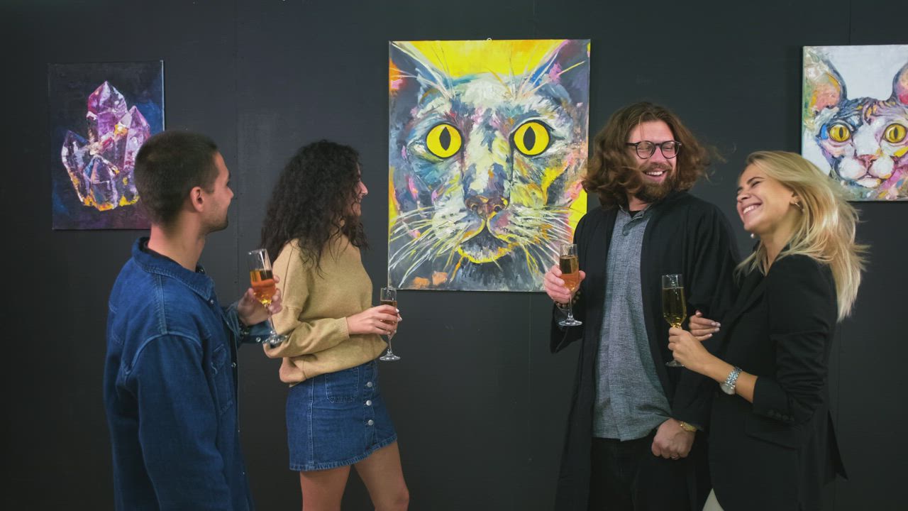 Group of people congratulating and celebrating the artist at gallery ...