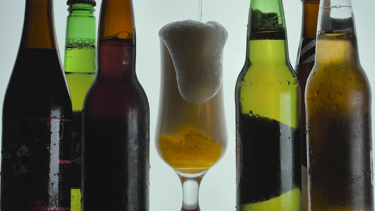 Foamy beer spilling from a glass - Free Stock Video