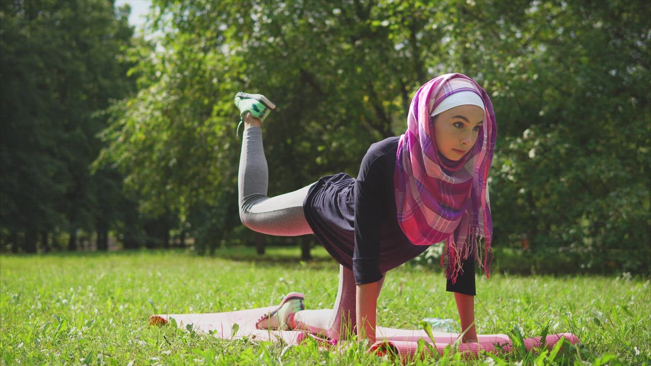 Muslim woman practicing sports in the park - Free Stock Video