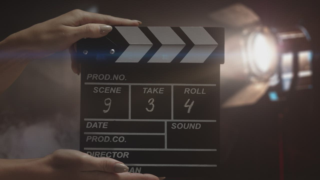 Clapperboard entering a frame to set a scene - Free Stock Video