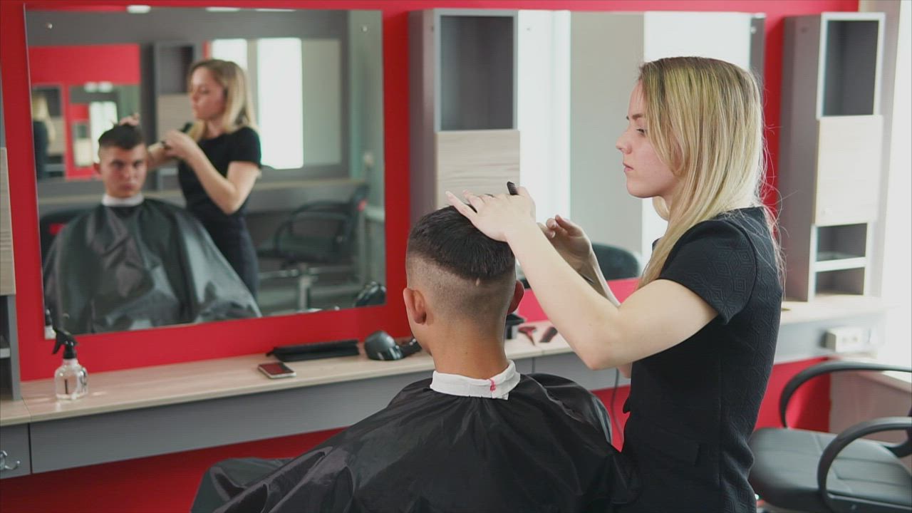 Hair stylist cuts a man's hair - Free Stock Video