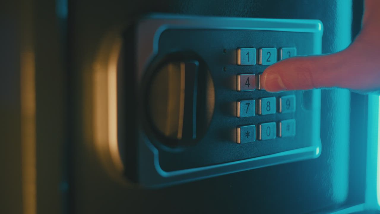 A man dialing a secret code to open a vault - Free Stock Video