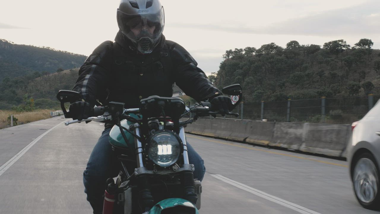 Front view of a biker on highway - Free Stock Video