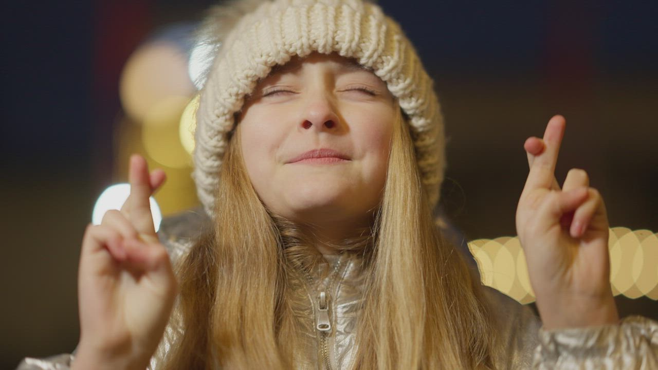 Young girl crossing fingers to make a wish - Free Stock Video