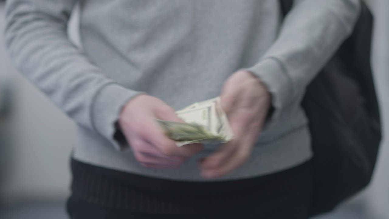 Man anxiously counting dollar bills - Free Stock Video