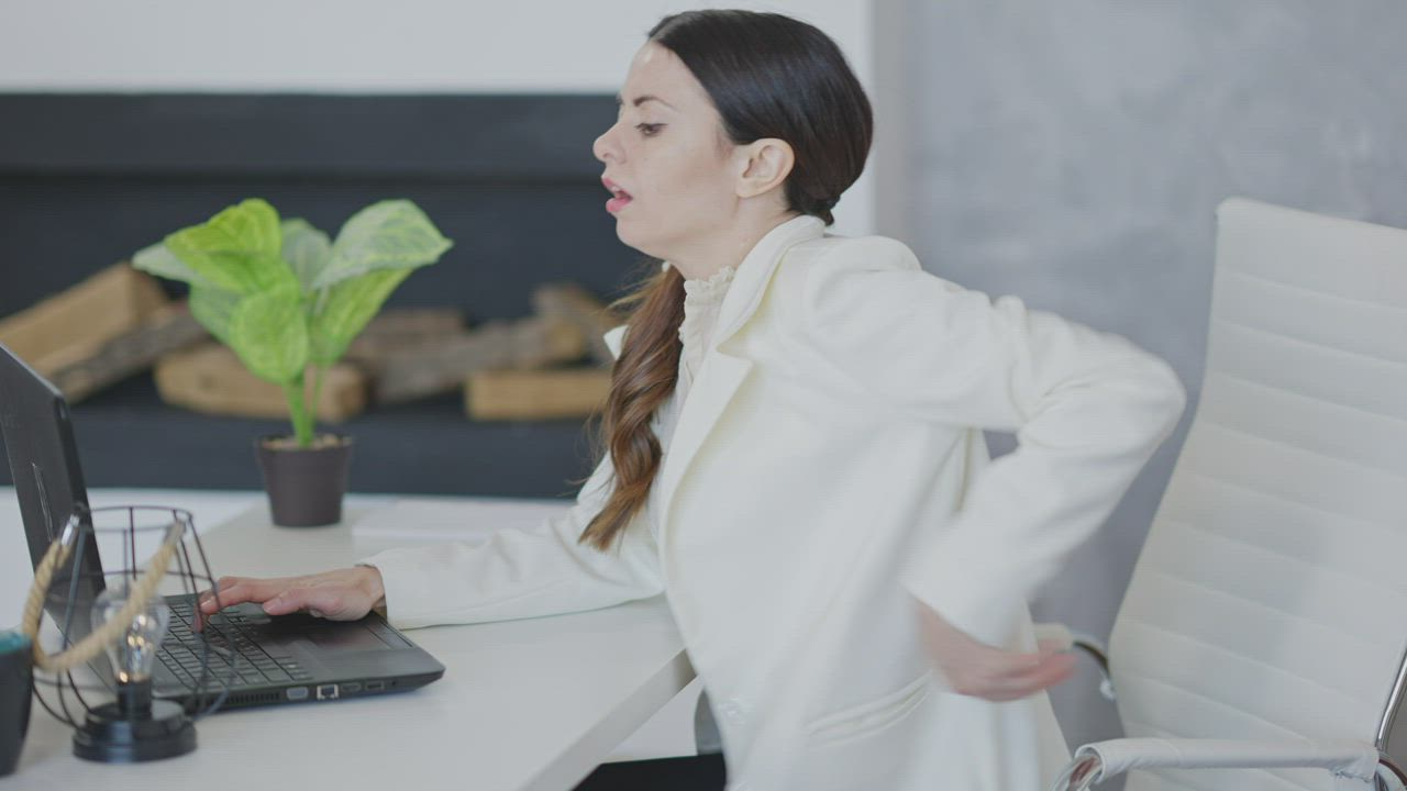 Working from home with lower back pain - Free Stock Video
