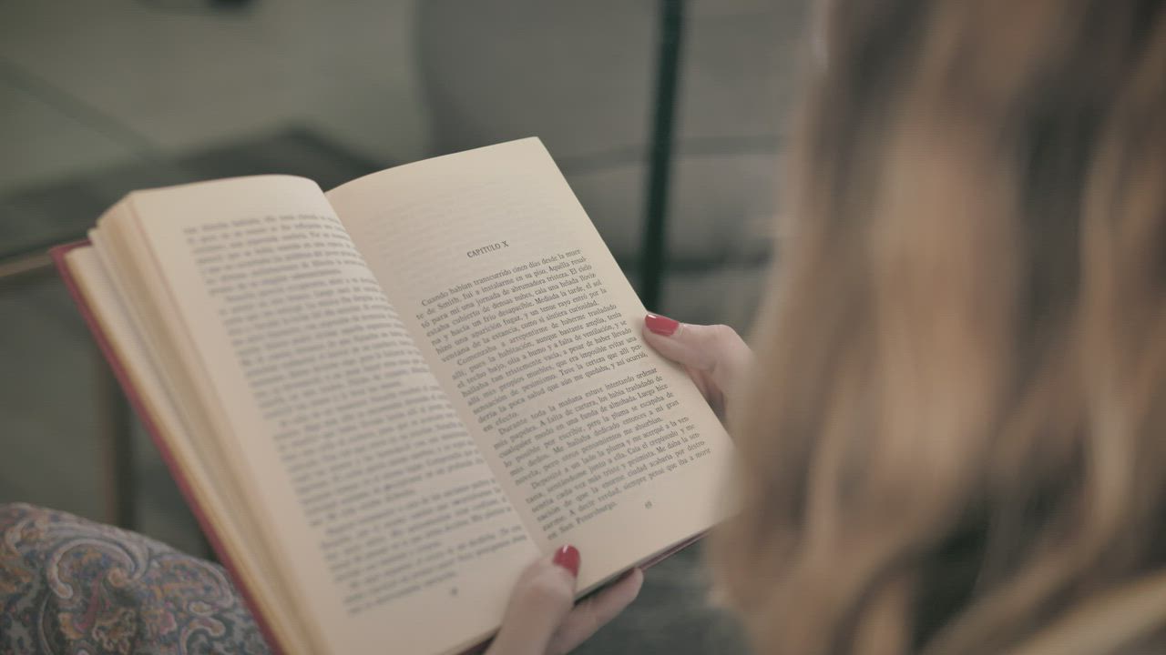 Blonde woman reading a book - Free Stock Video