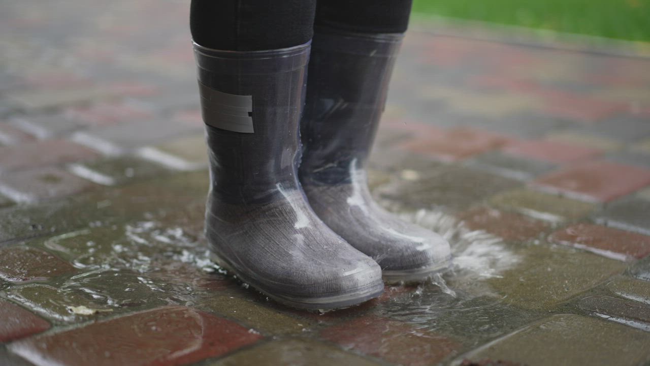 Close up of a child having fun in a puddle - Free Stock Video