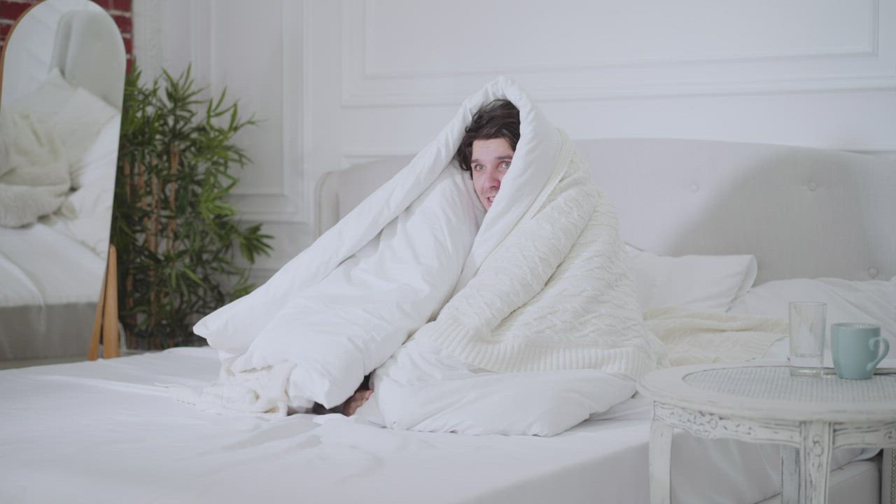 Young man with cold inside the bed - Free Stock Video