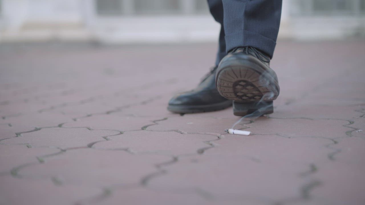 Stomping a cigarette with the foot - Free Stock Video