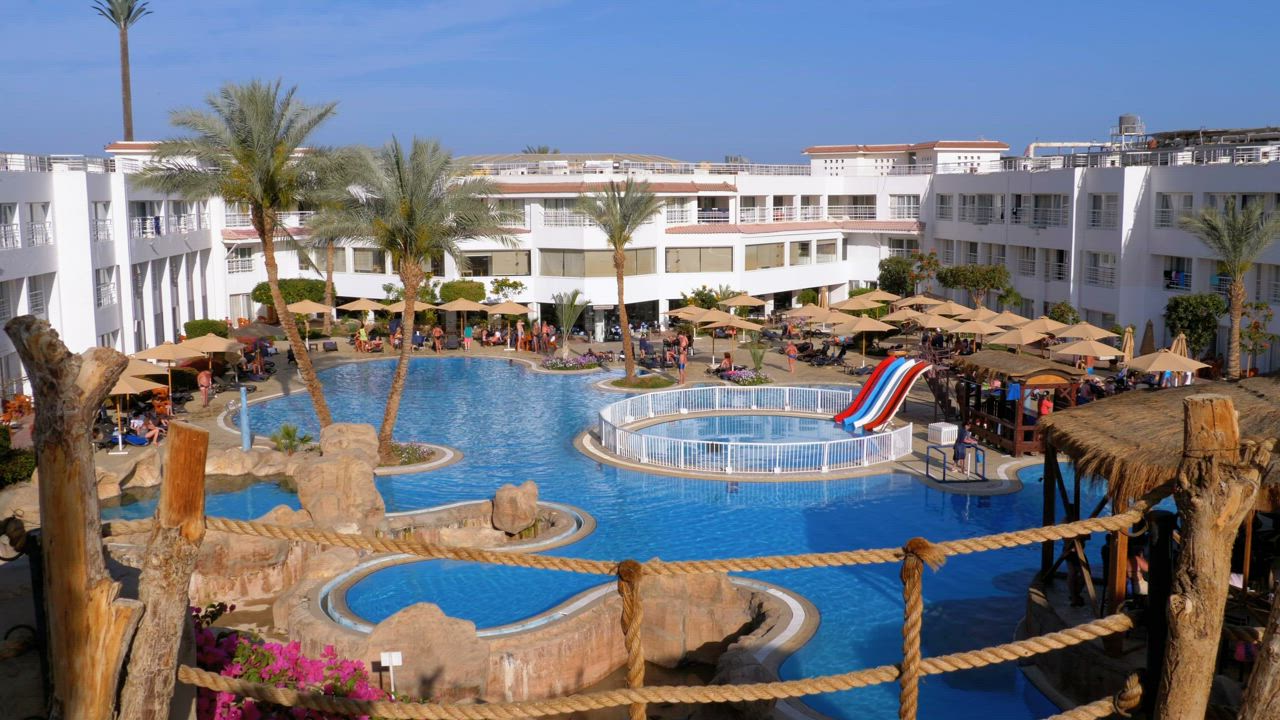 Sunny hotel resort with waterslides by the pool - Free Stock Video