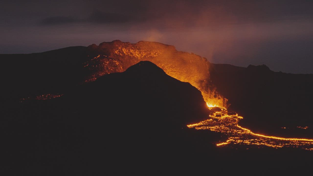 Lava surrounding a volcano during eruption - Free Stock Video