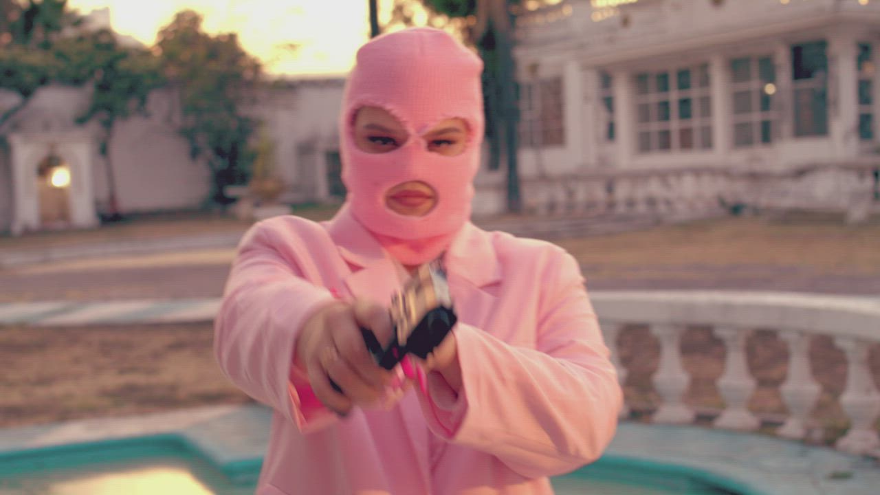 A young thug in a pink ski mask shows off her firearm - Free Stock Video