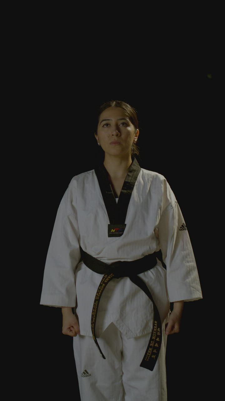A young karateka woman makes a reverence movement - Free Stock Video