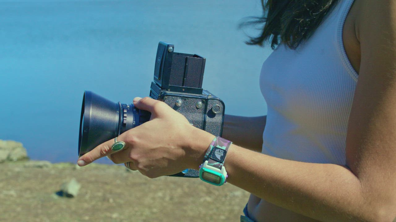 A young woman holding a old fashioned camera with her hands. - Free ...