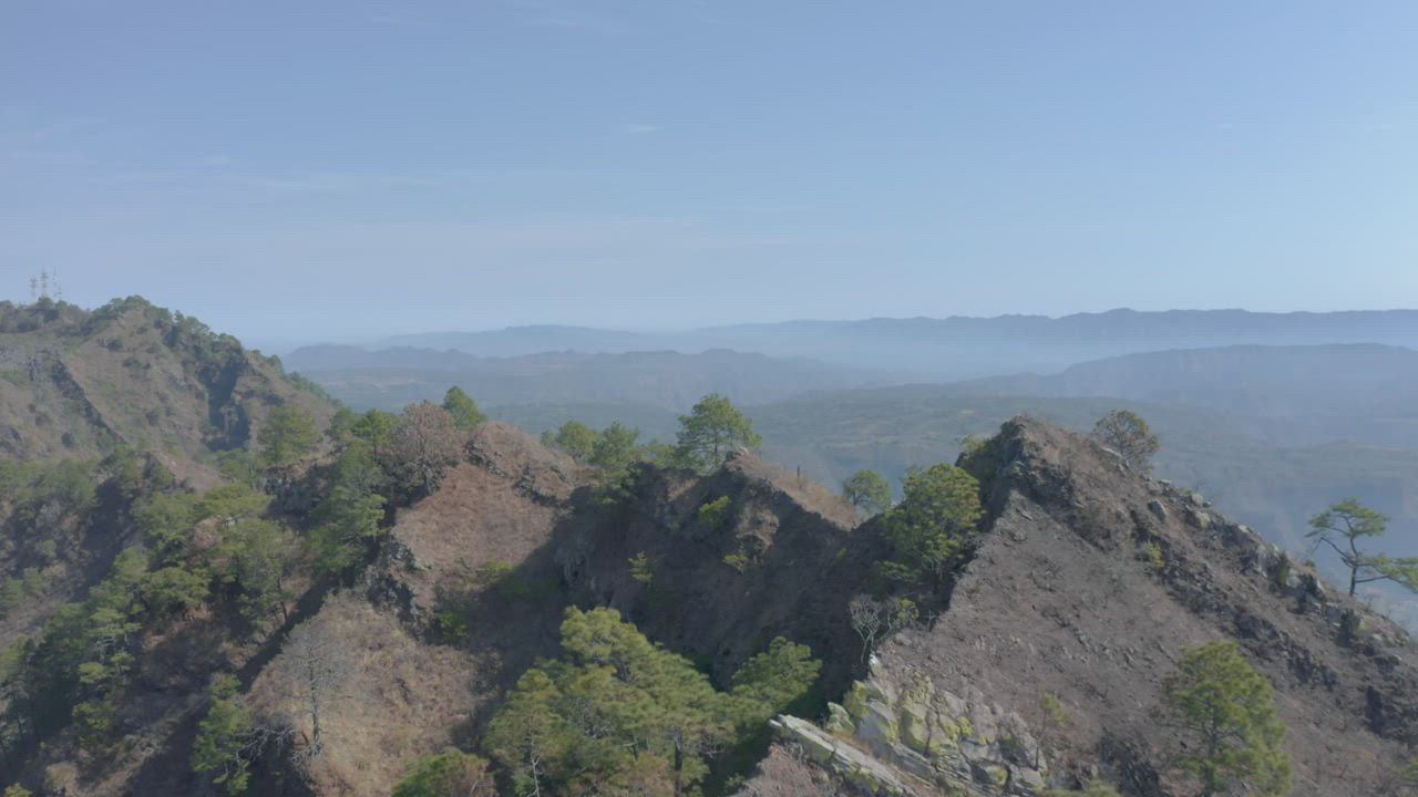 Aerial view of a rocky mountain on a sunny day - Free Stock Video