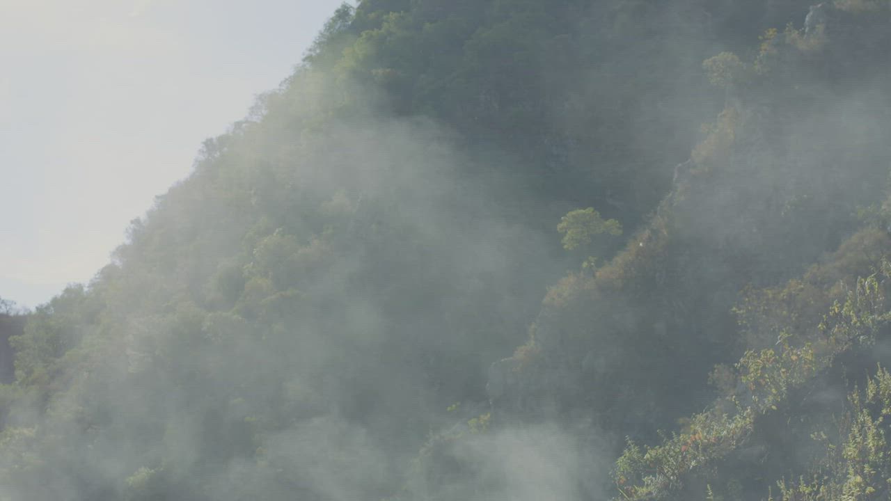Close view to the surface of a hill with steam - Free Stock Video