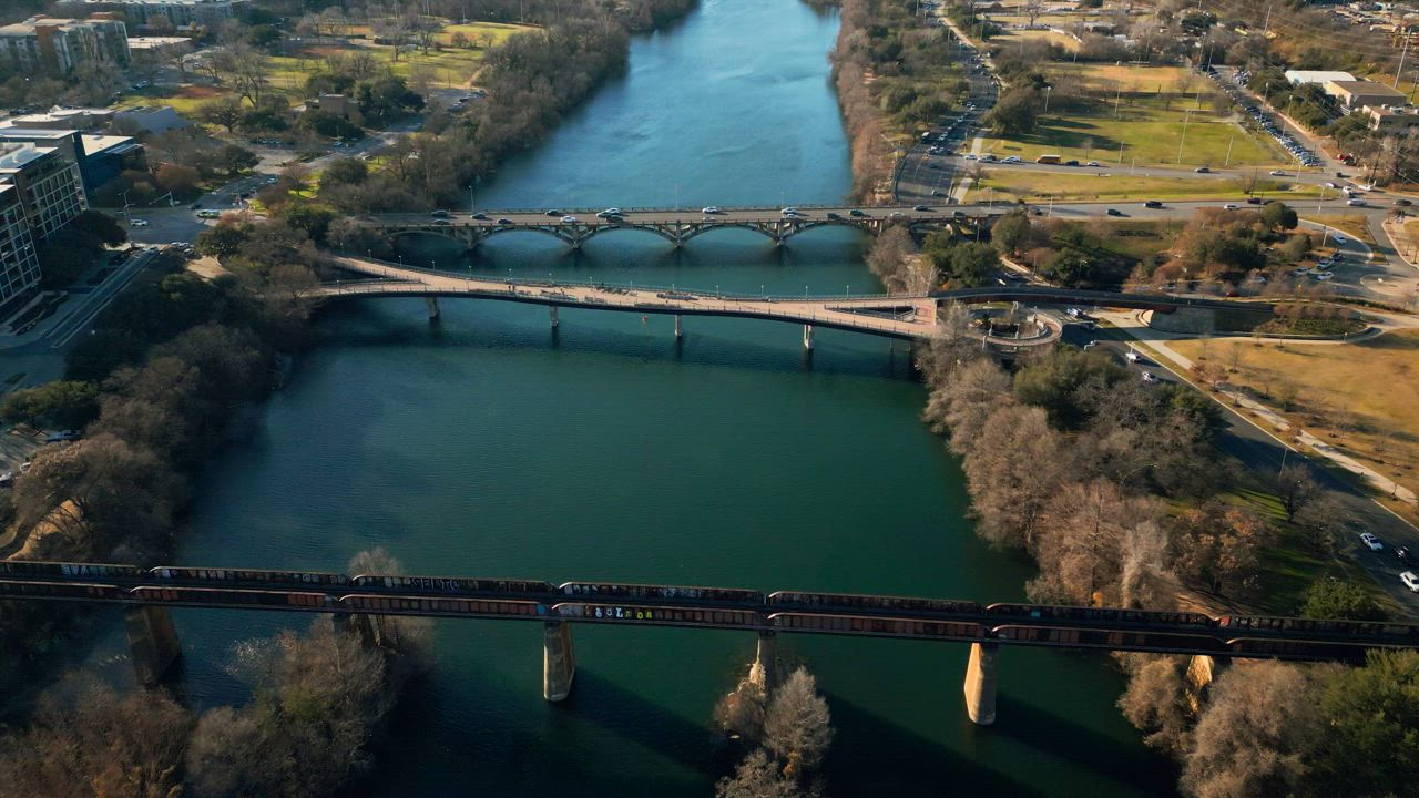 Big river with bridges in a city in an aerial view - Free Stock Video