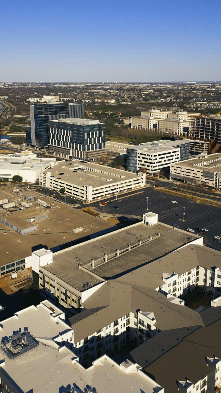 Flying slowly over a city in the afternoon - Free Stock Video