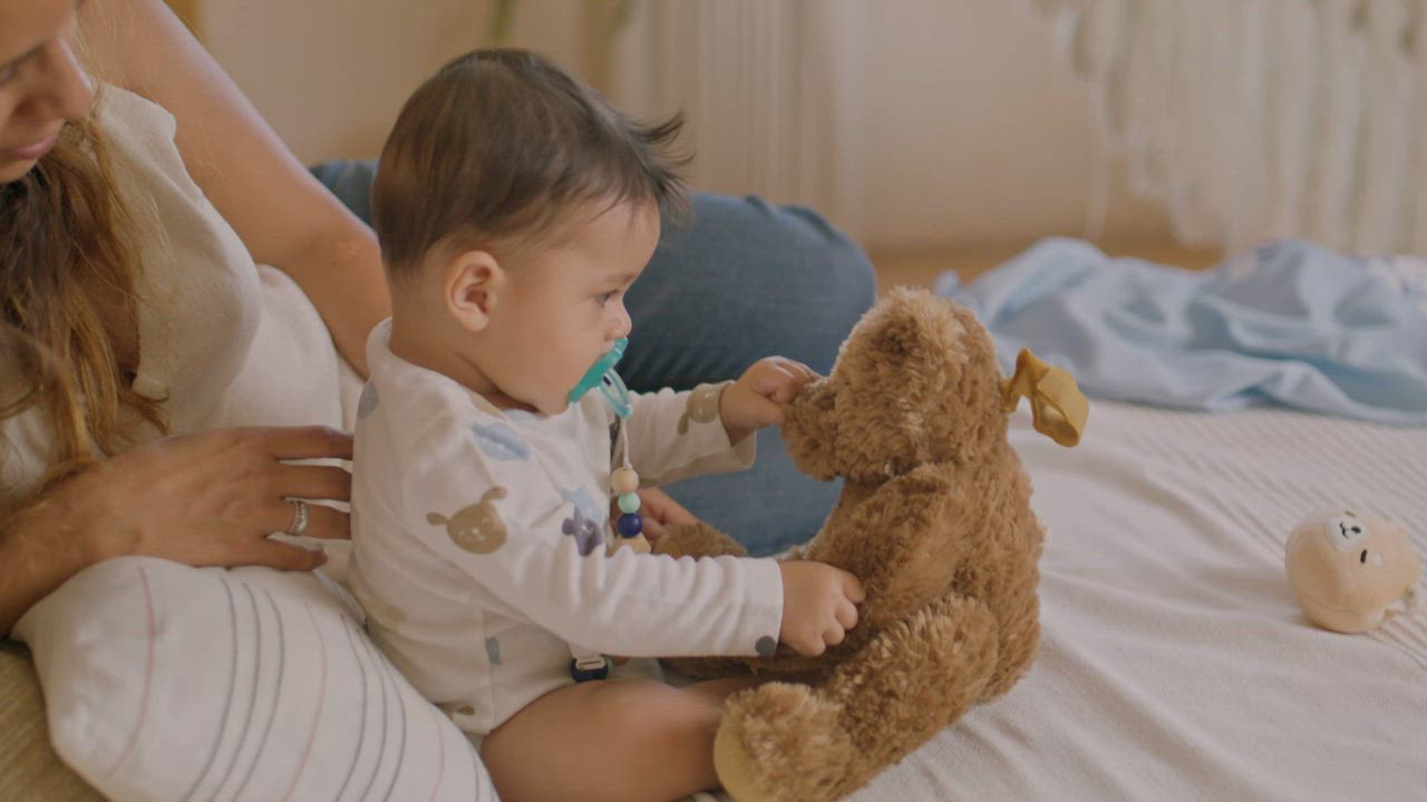 Mother and her baby playing with a teddy bear - Free Stock Video