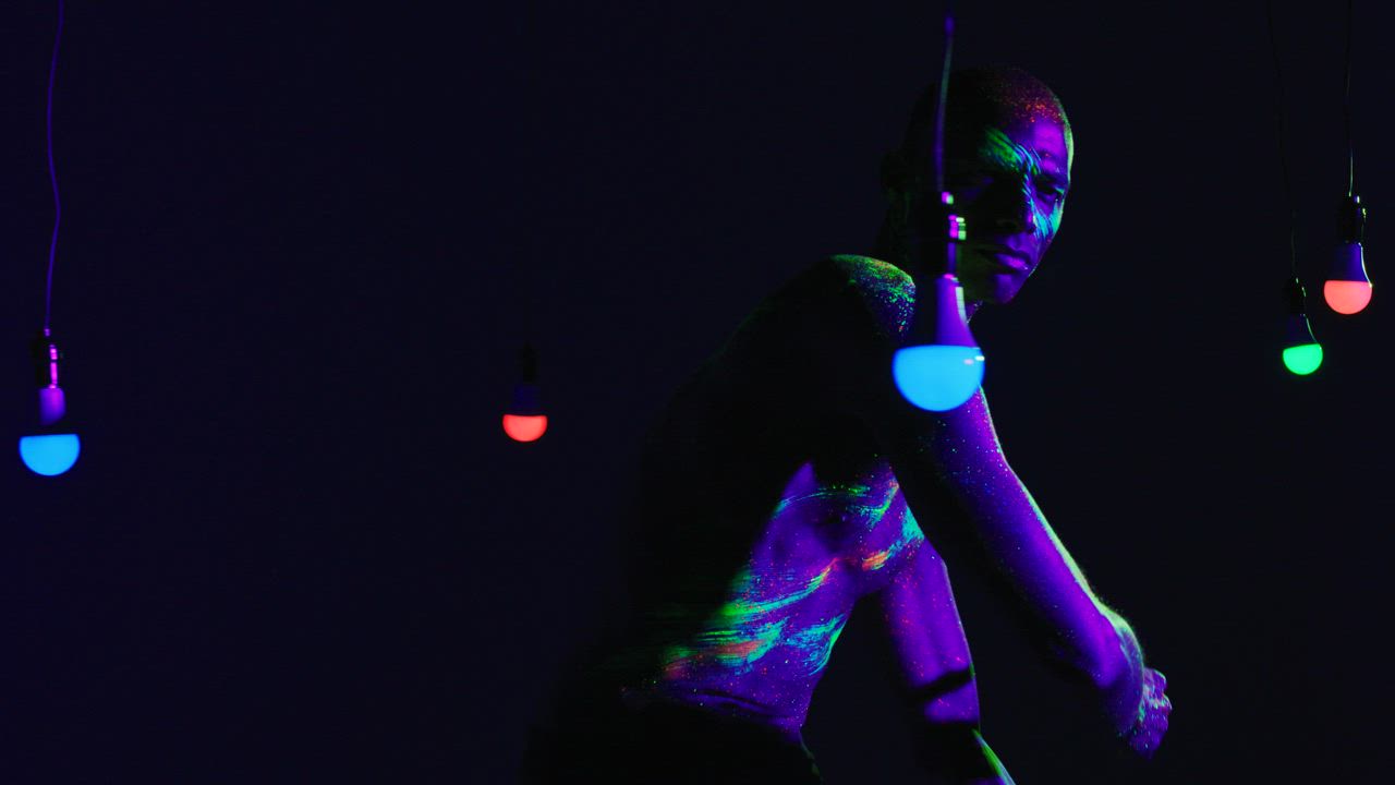 Man painted fluorescent in the dark - Free Stock Video