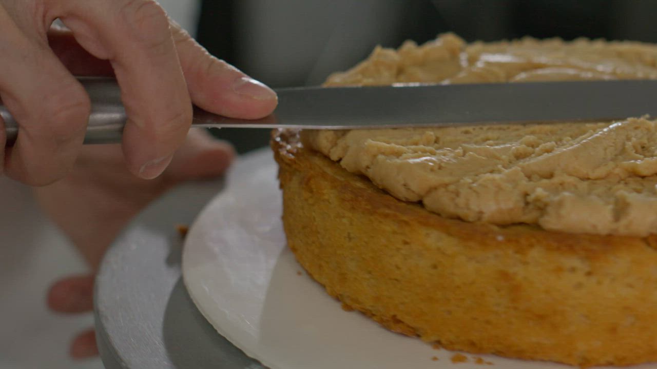 Pastry chef putting the filling on a cake - Free Stock Video