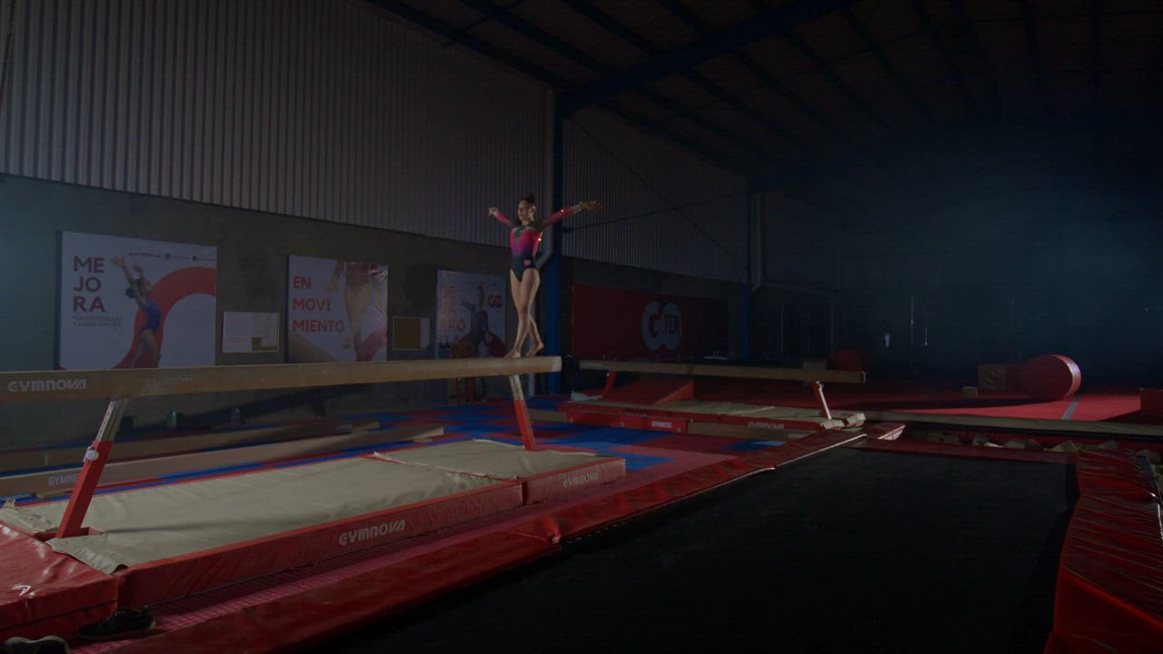 Gymnast practicing her balance on a balance beam - Free Stock Video