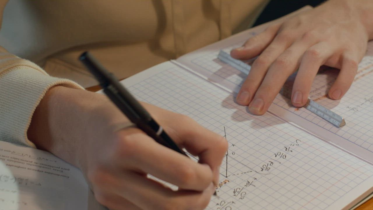 A student making notes and mathematical charts on the notebook - Free ...