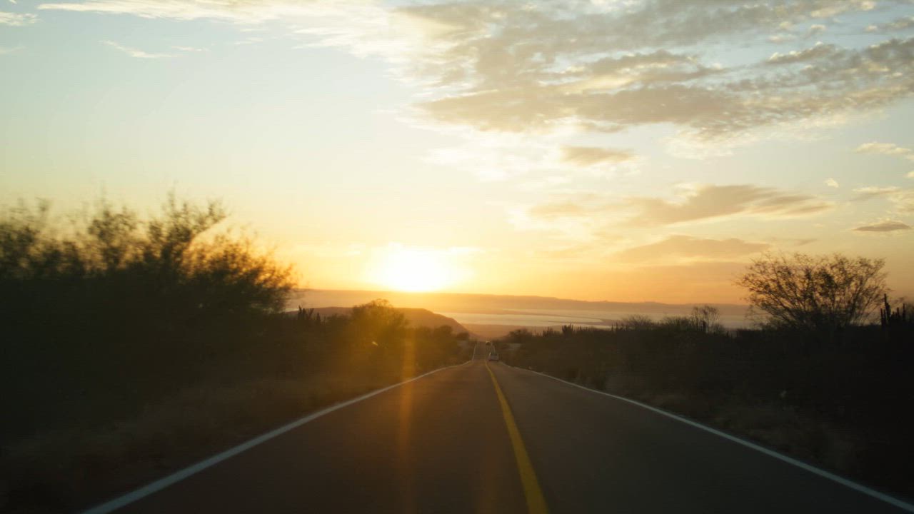 Two cars followed each other on the road at sunset - Free Stock Video