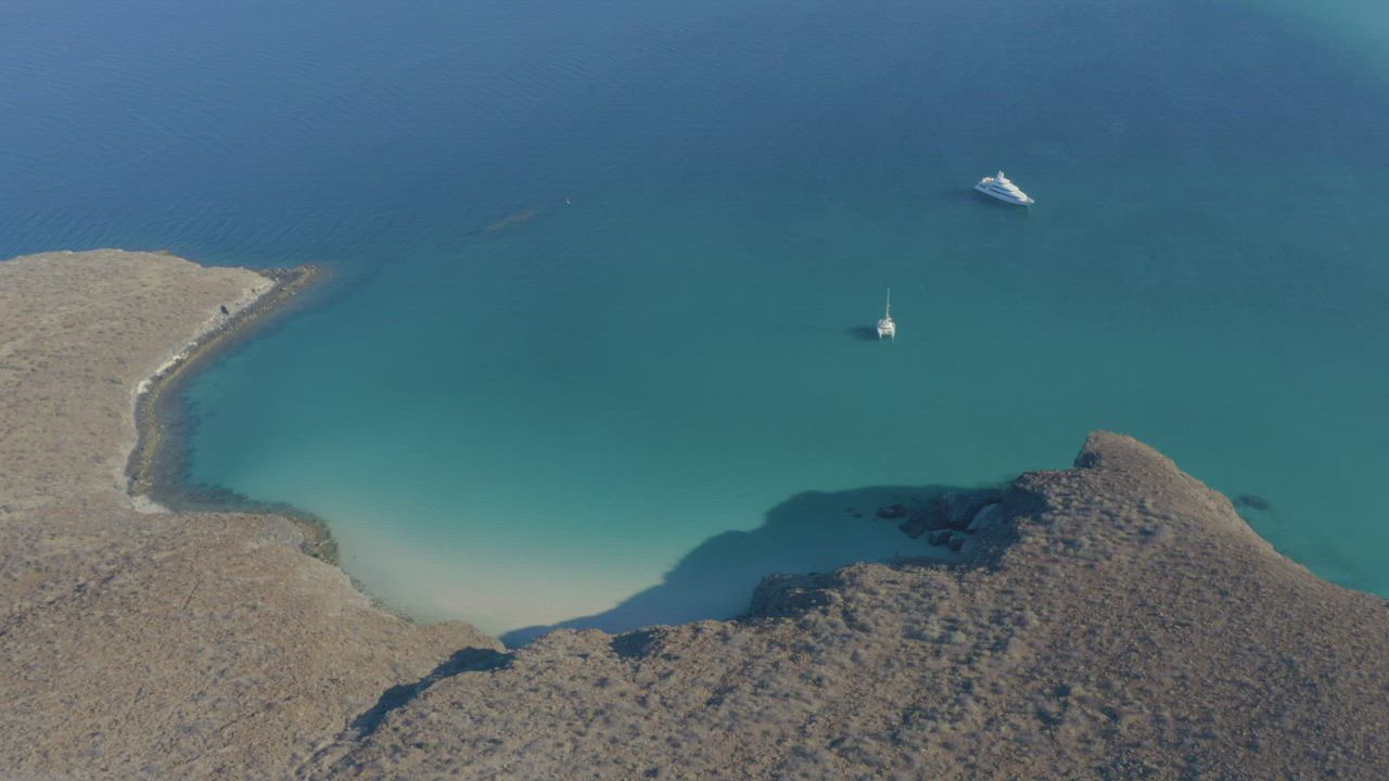 Aerial view of the mouth of an estuary in the sea - Free Stock Video