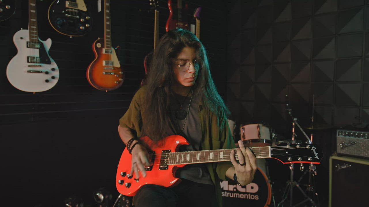 Skilled Guitarist Rocking Red Electric Guitar in Store - Free Stock Video