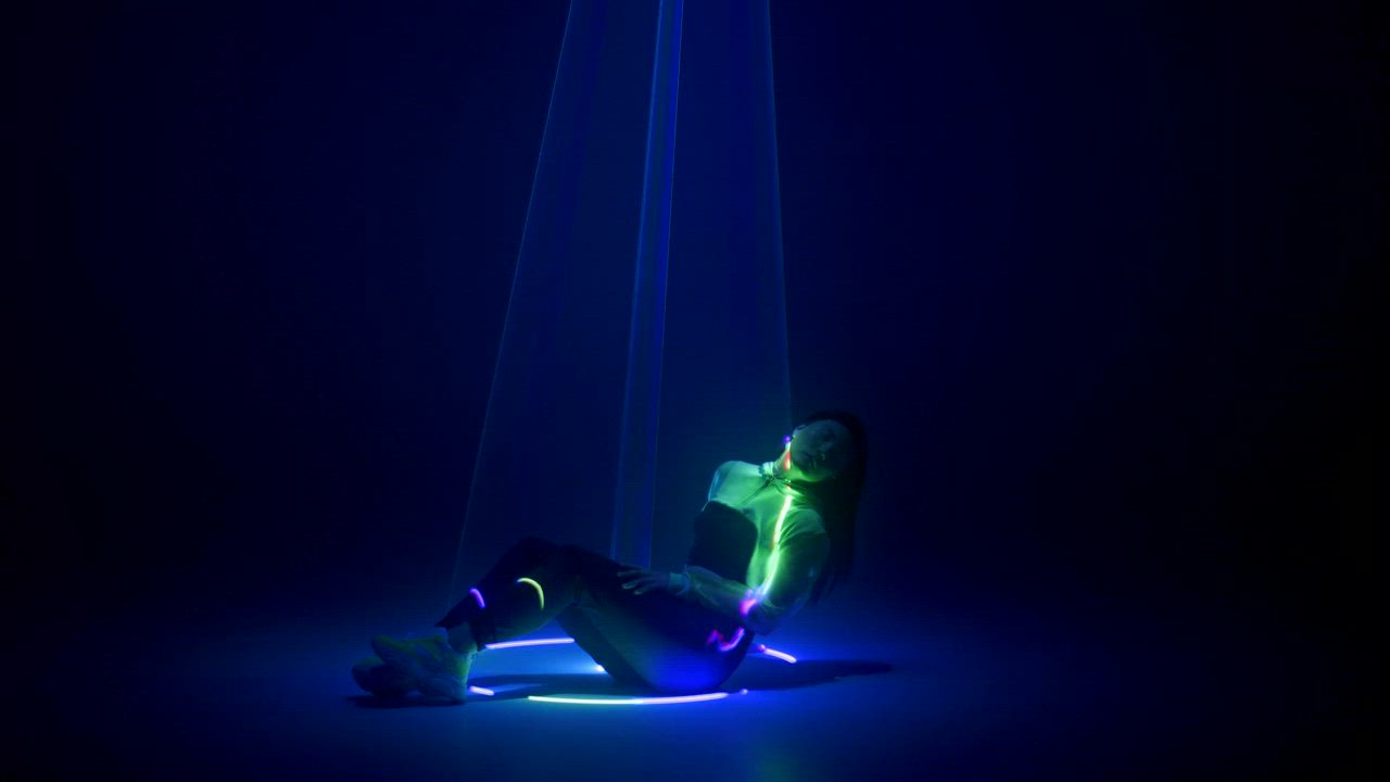 Neon spotlight and a dancer - Free Stock Video
