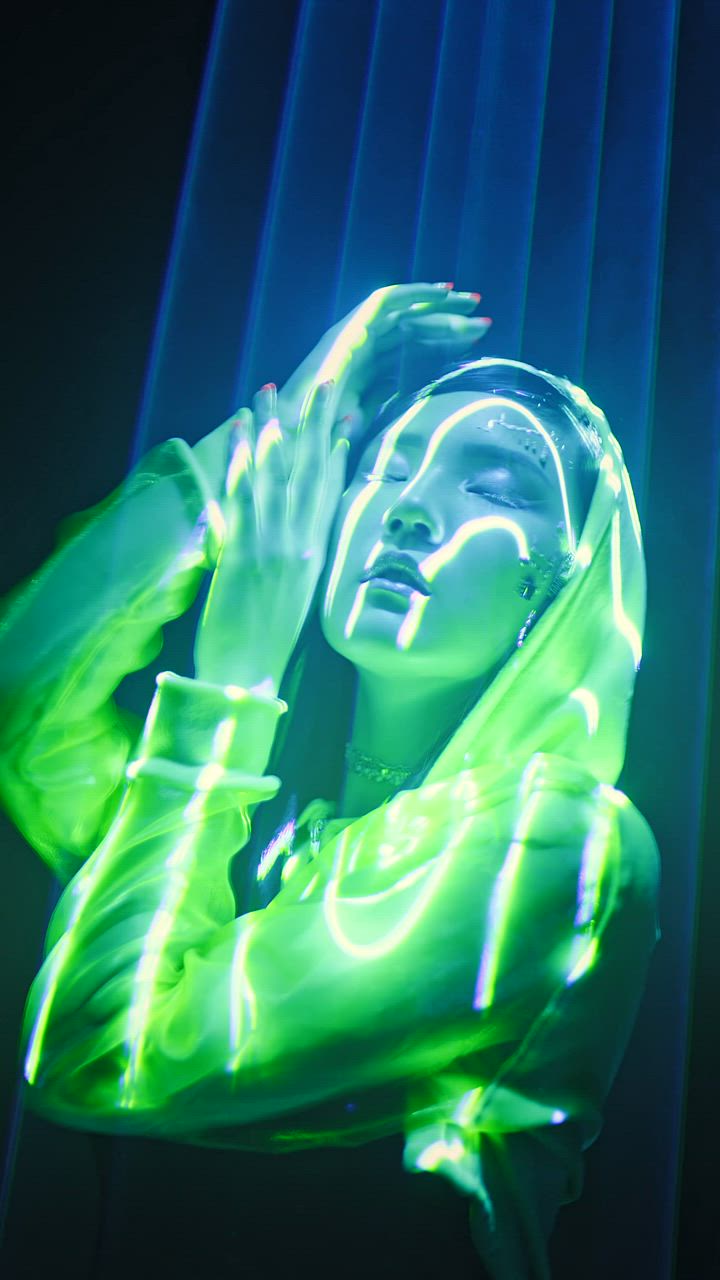 Young woman dancing under neon lights - Free Stock Video