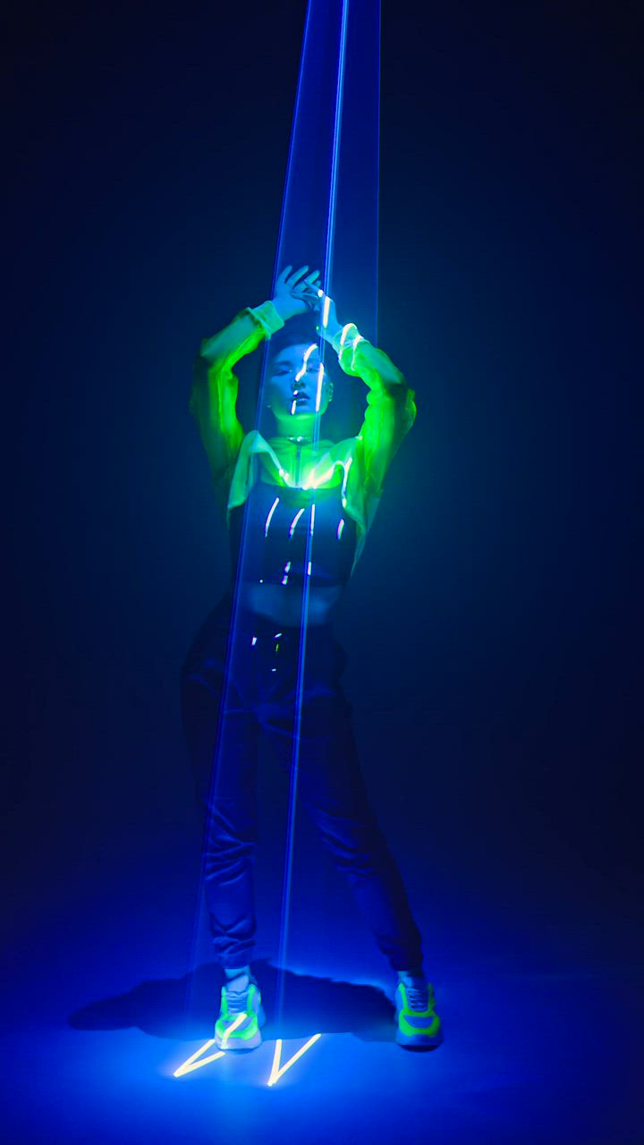 Young woman dances and moves slowly underneath neon lights - Free Stock ...