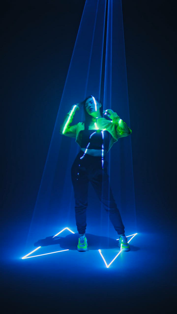 Young woman dances and moves slowly underneath green neon lights - Free ...