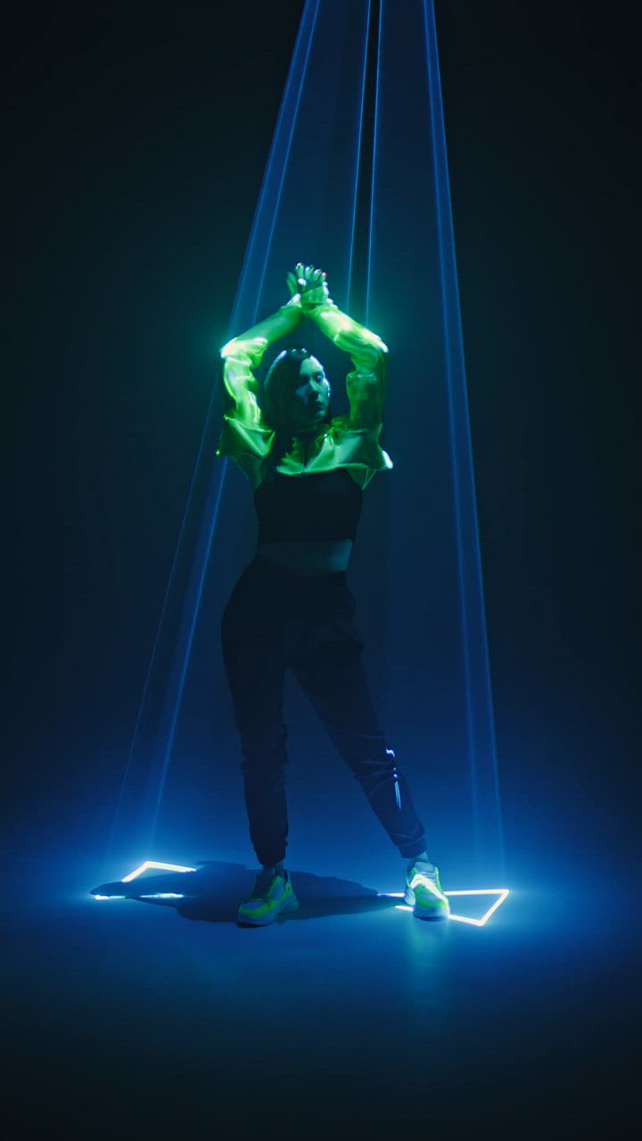 Young woman dances and moves slowly underneath laser lights - Free ...