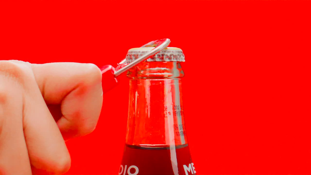 A glass bottle of soda being opened with a retro soda opener - Free ...