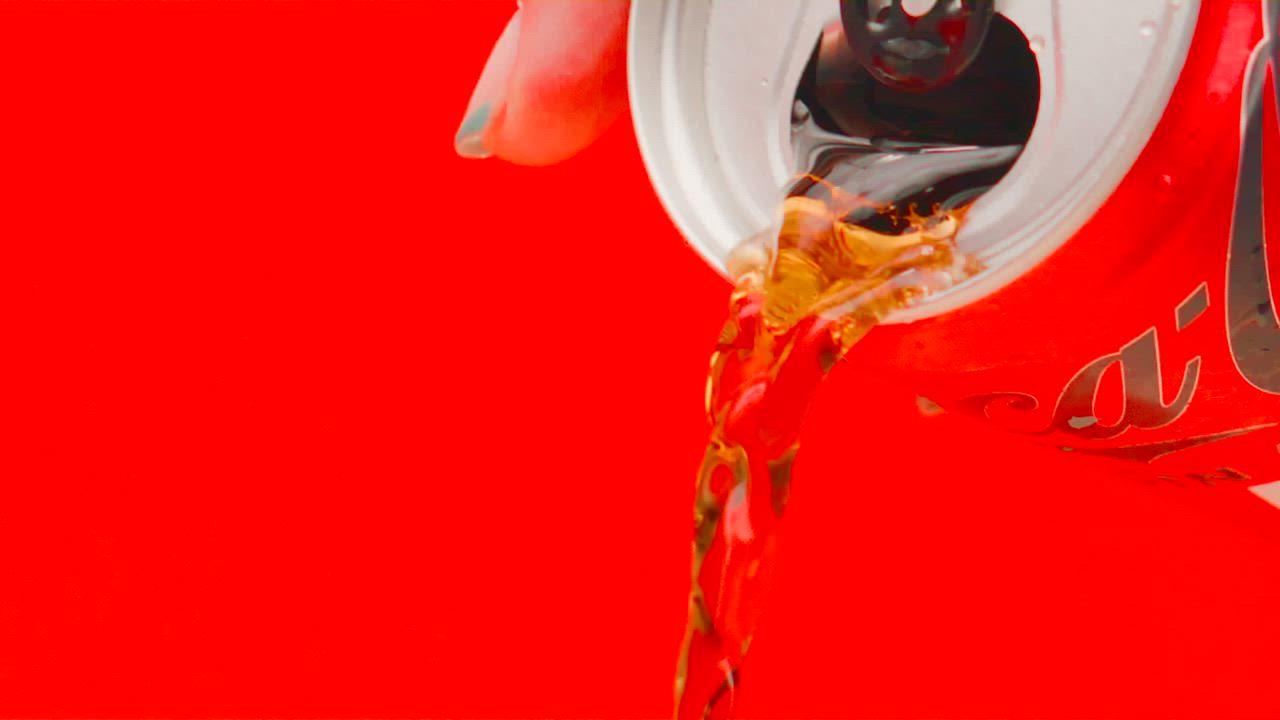 Hand holds a can while pouring coke - Free Stock Video