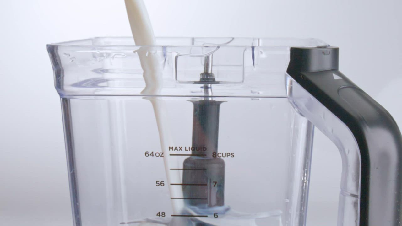 A continuous stream of milk falling into an empty blender - Free Stock ...